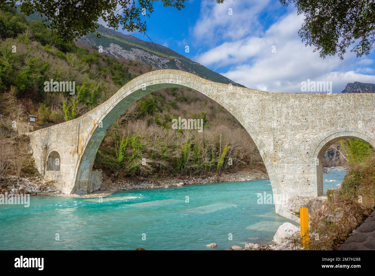 The great arched stone bridge of Plaka on Arachthos river, Tzoumerka ...