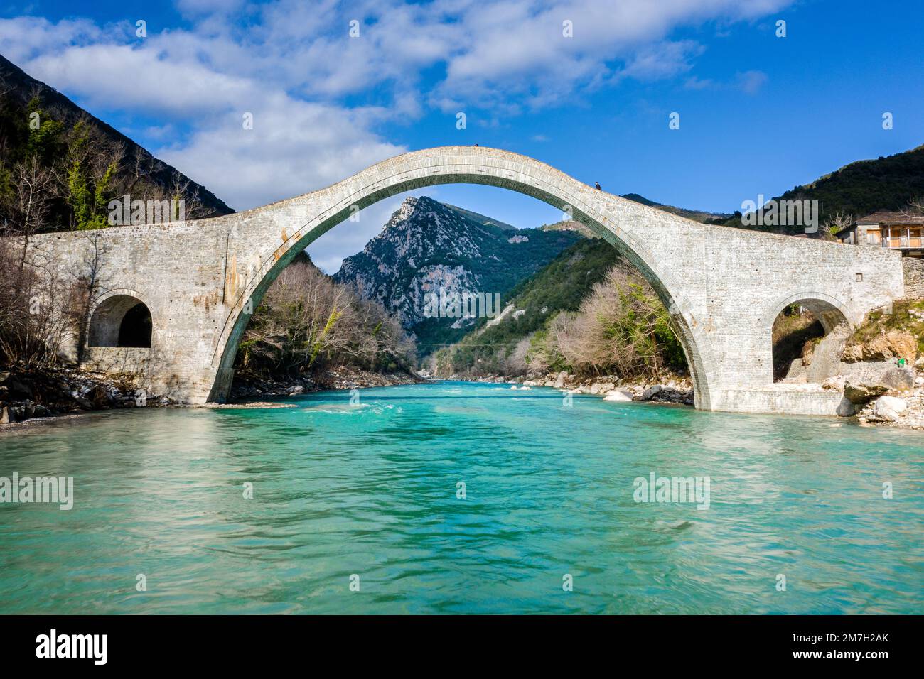 The great arched stone bridge of Plaka on Arachthos river, Tzoumerka ...