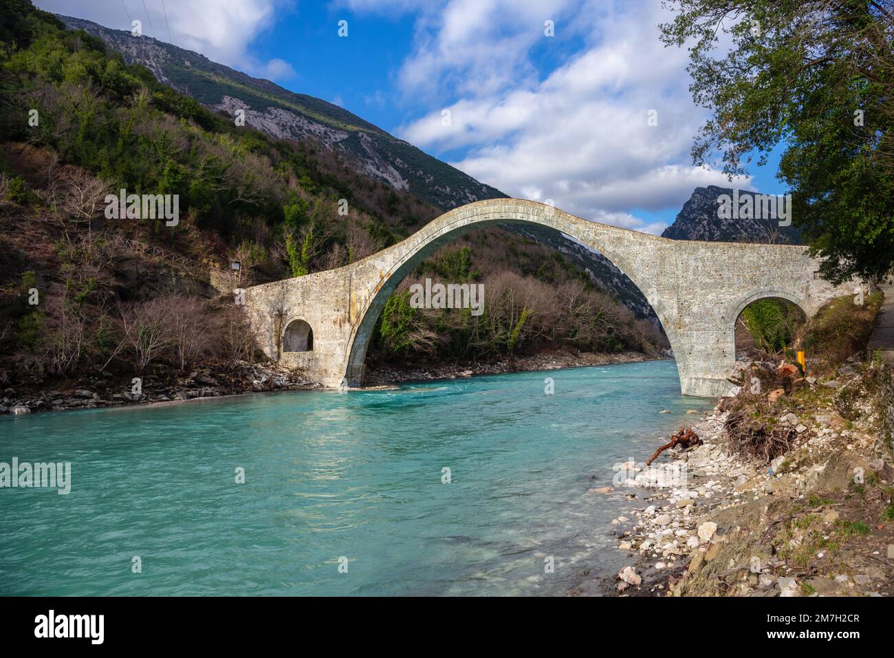 The great arched stone bridge of Plaka on Arachthos river, Tzoumerka ...