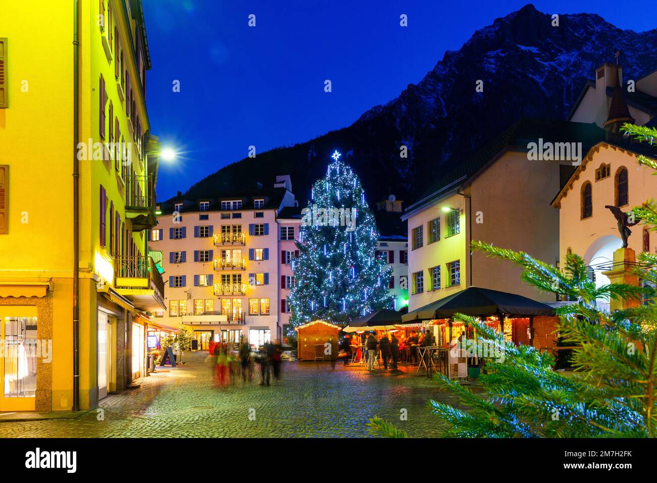 Night view of Brig street with Christmas tree on background of Alps ...