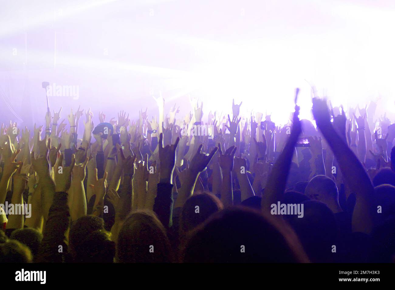 Hands up place for text. Fans are screaming. Teenagers at a concert ...