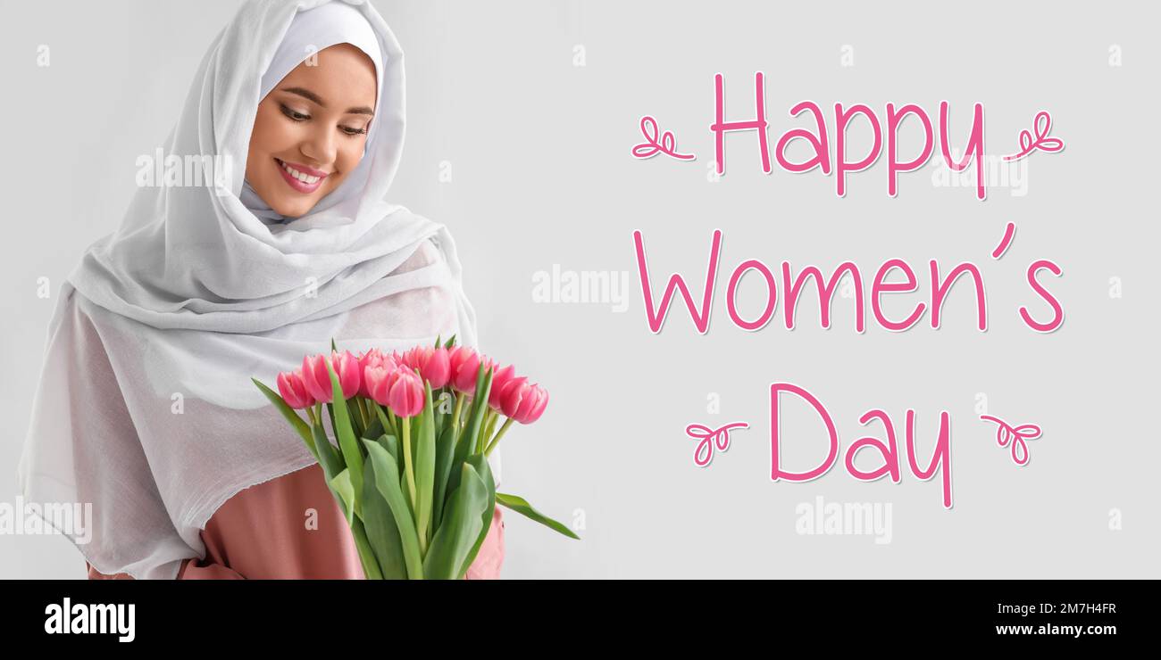 Muslim woman with bouquet of tulips on light background. International ...