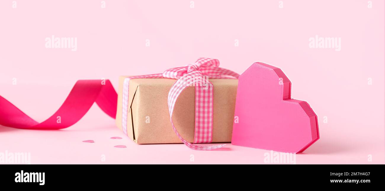 Beautiful gift box and heart on pink background. Valentine's Day ...