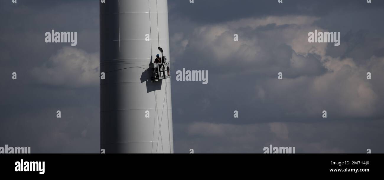 a worker working on a modern wind turbine tower panorama Stock Photo ...