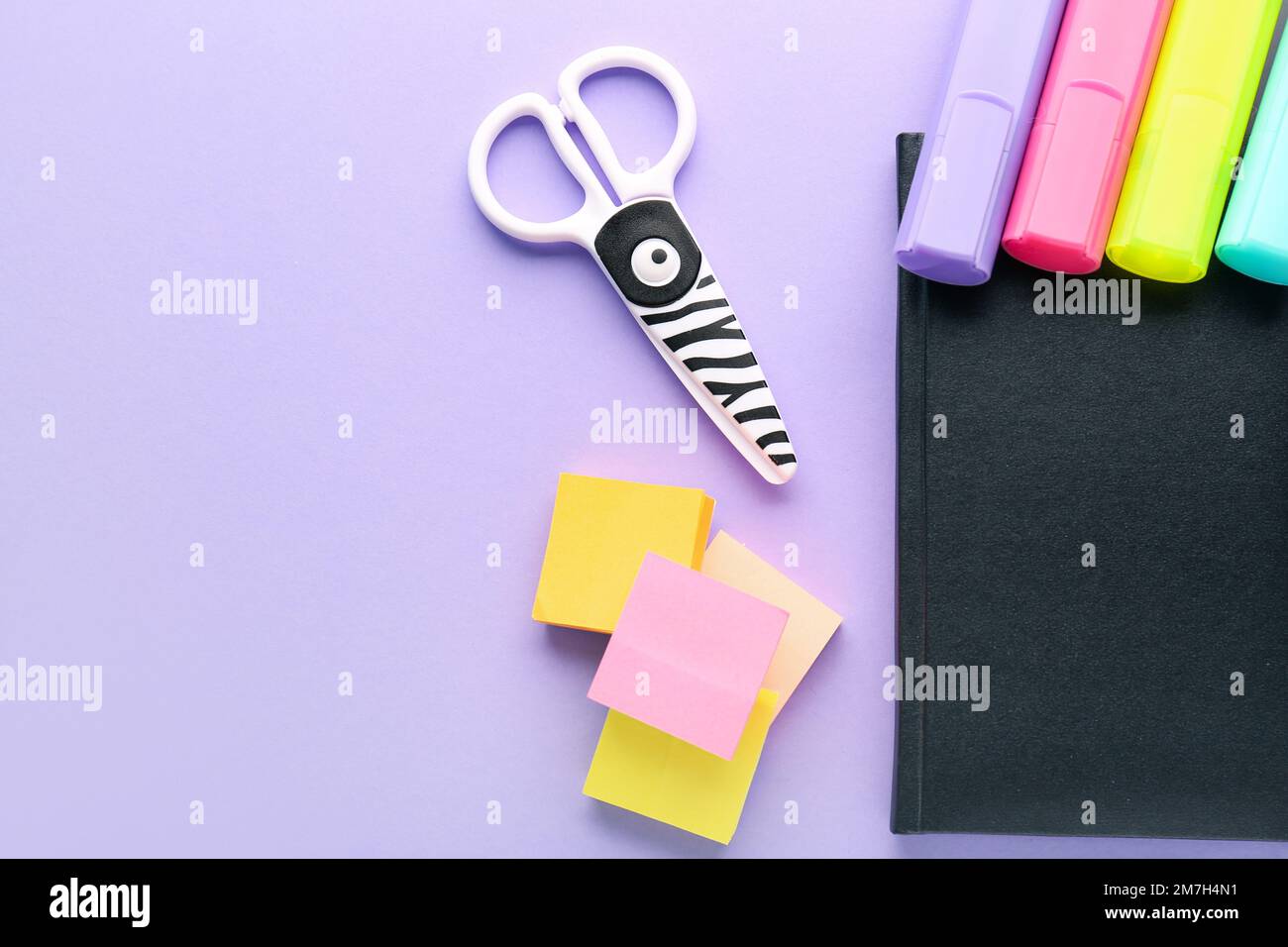 Scissors, markers, sticky notes and notebook on lilac background Stock ...