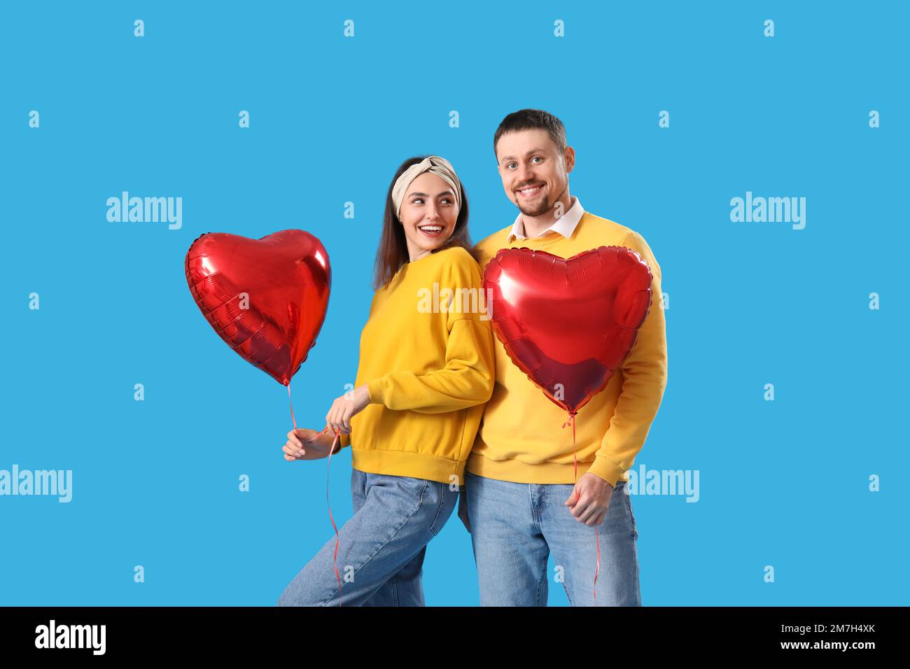 Happy couple in love with balloons on blue background. Valentine's Day ...