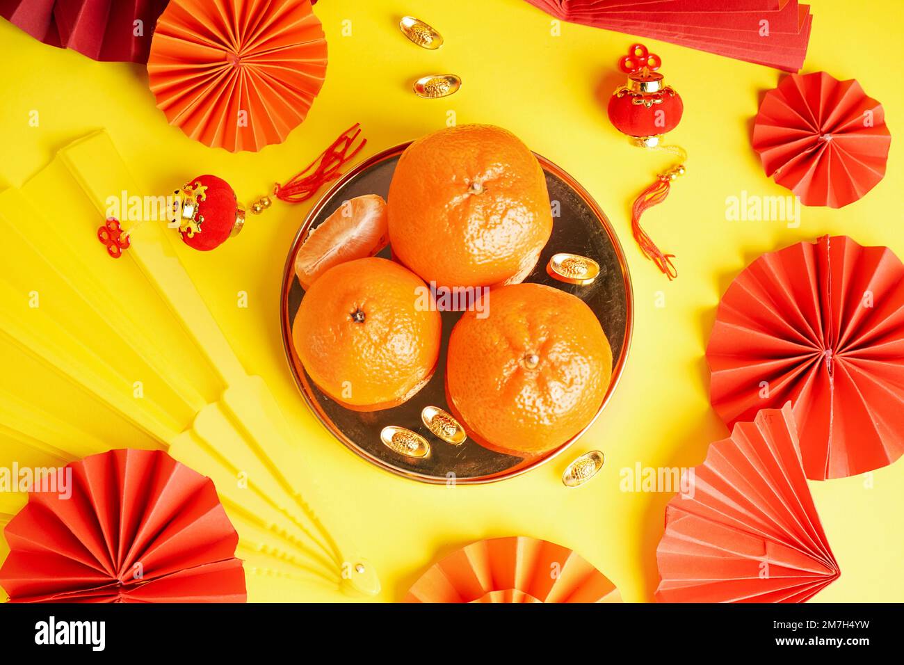 Mandarins with Chinese symbols on yellow background Stock Photo - Alamy