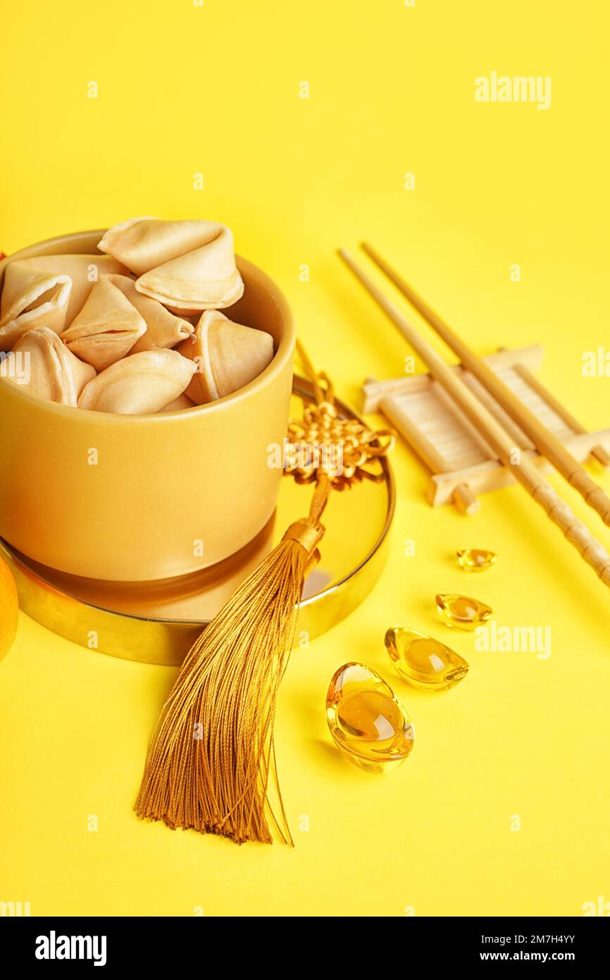 Bowl of fortune cookies and Chinese symbols on yellow background Stock ...