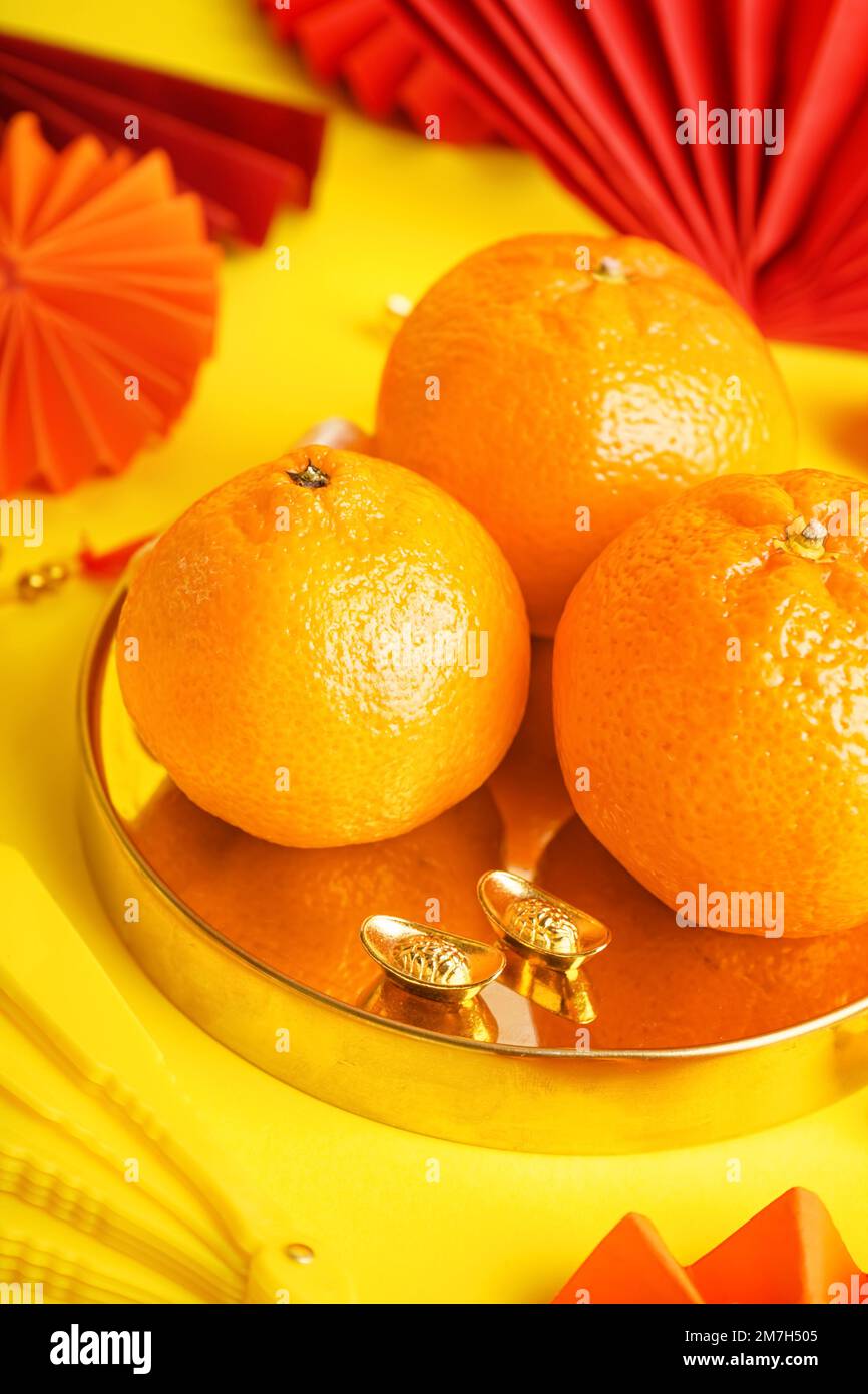 Mandarins with Chinese symbols on yellow background, closeup Stock ...