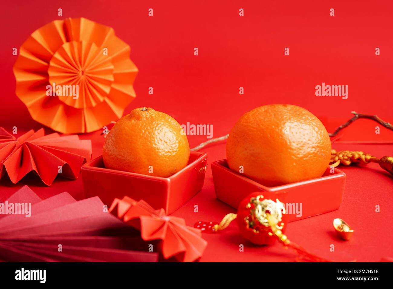 Mandarins and Chinese symbols on red background, closeup Stock Photo ...