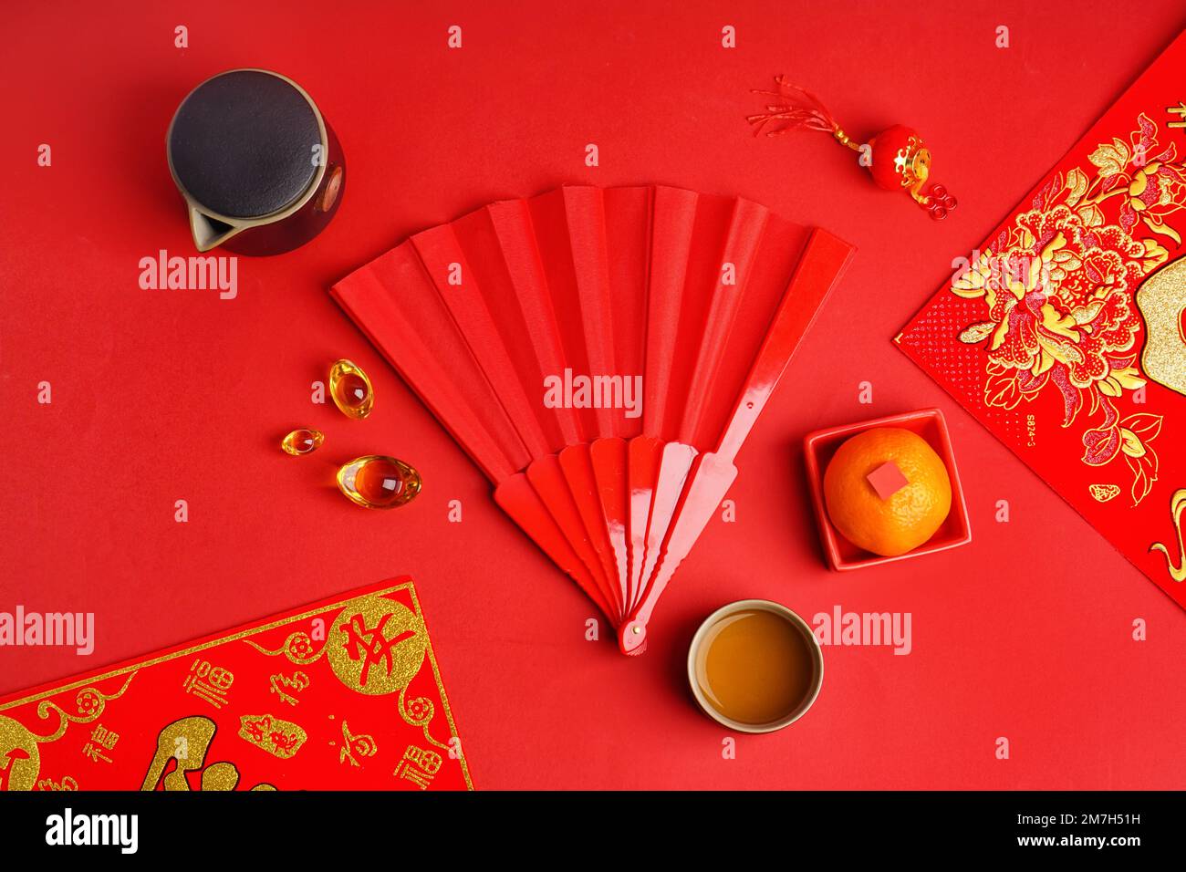 Teapot, cup of tea, mandarin and Chinese symbols on red background ...