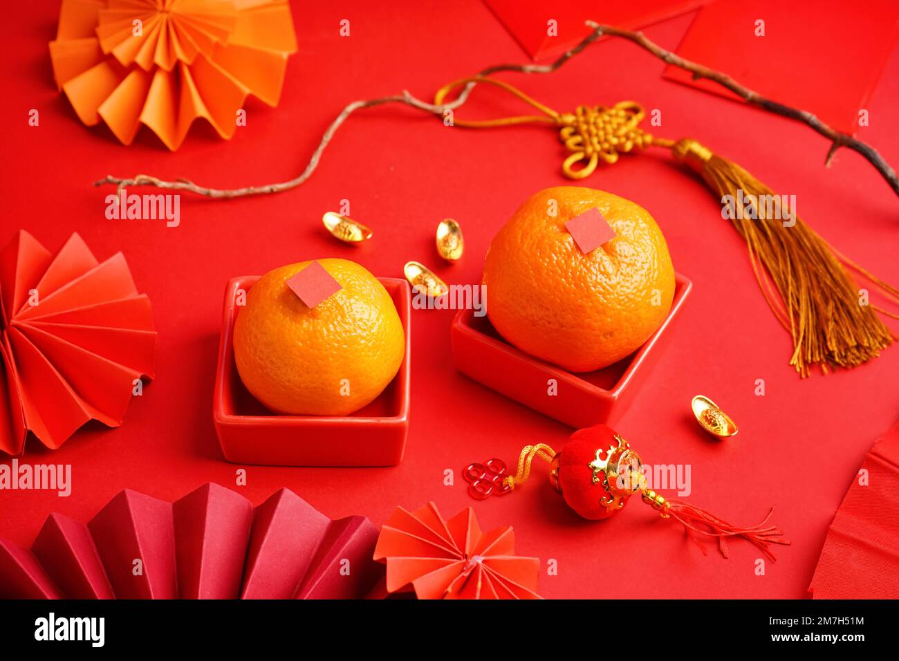 Mandarins and Chinese symbols on red background, closeup Stock Photo ...