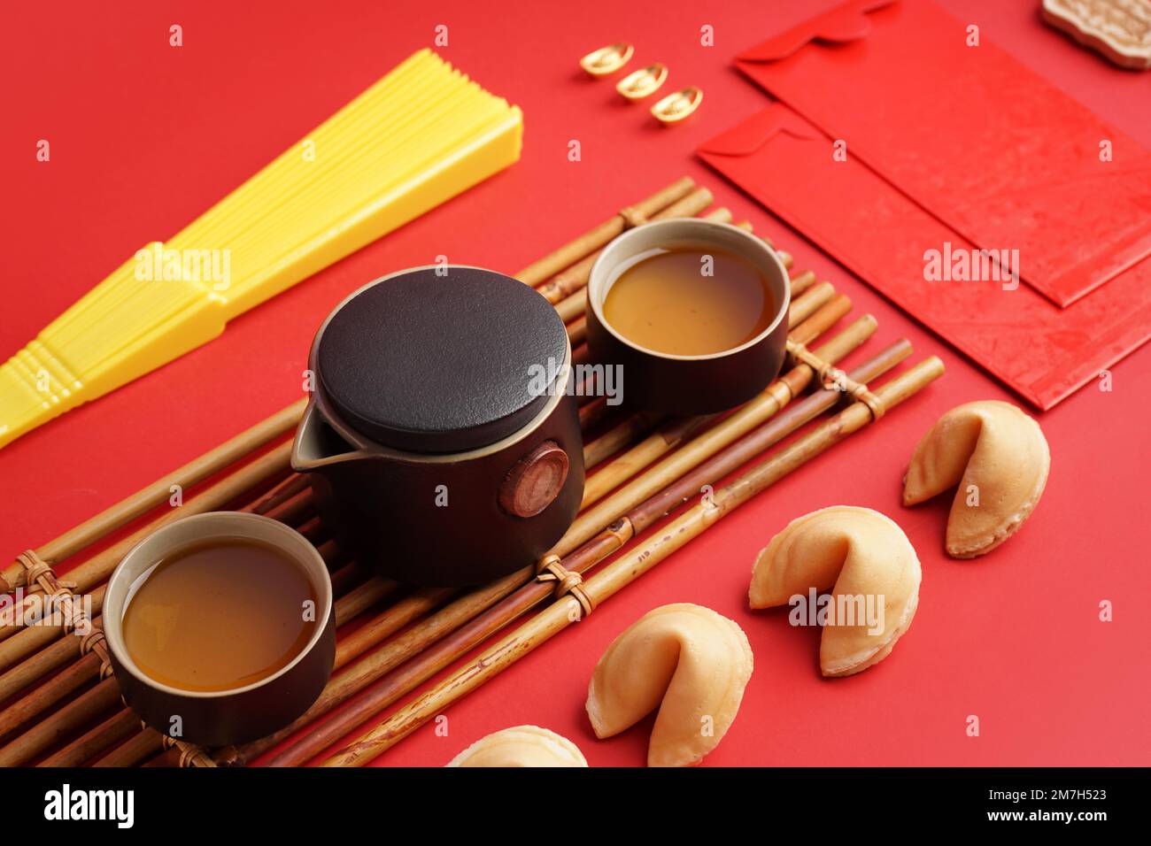 Teapot, cups of tea, envelopes and Chinese symbols on red background ...