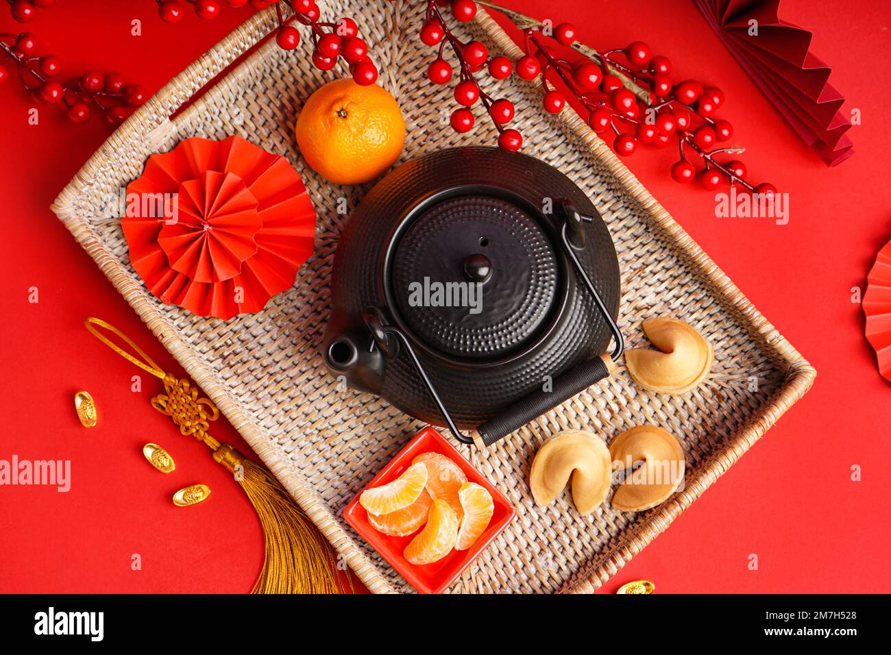 Tray with teapot, fortune cookies, mandarin and Chinese symbols on red ...