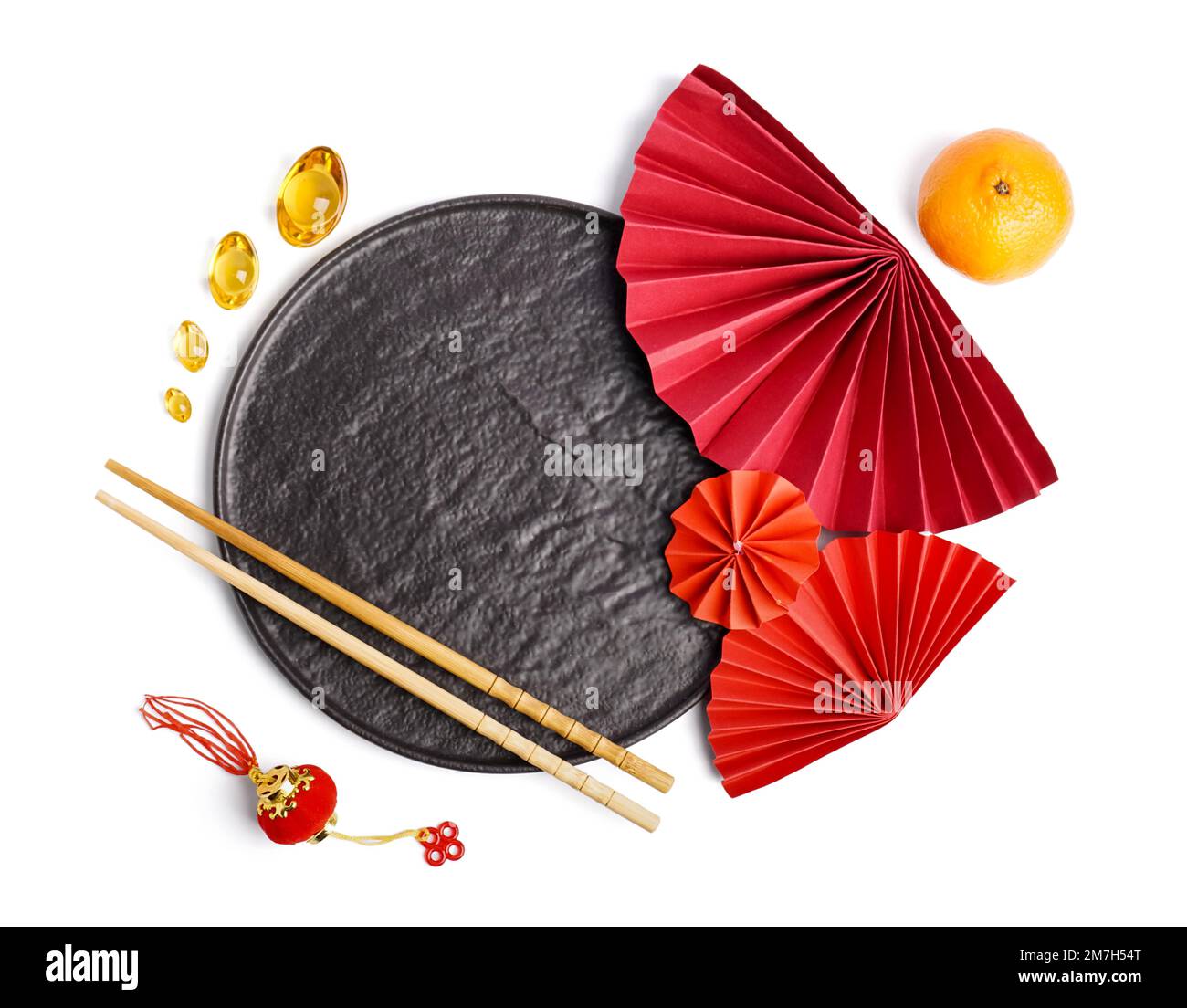 Table setting with mandarin and Chinese symbols on white background ...