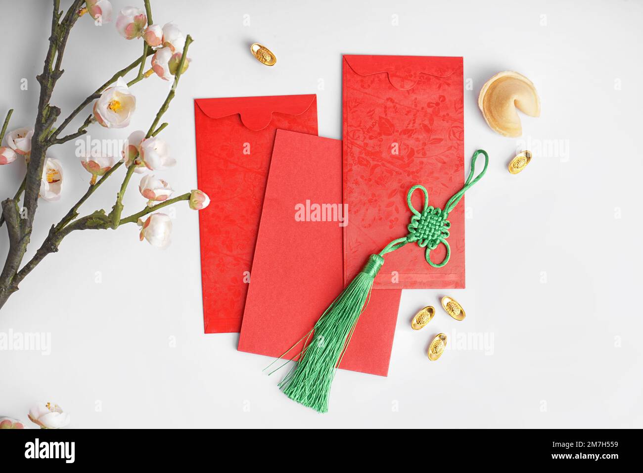 Red envelopes, fortune cookie and Chinese symbols on white background ...