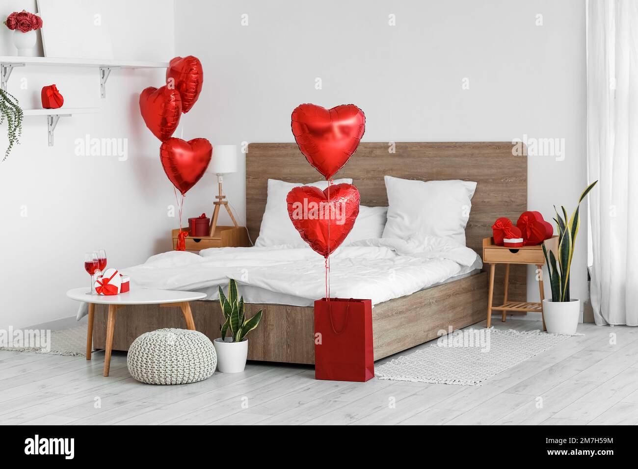 Interior of bedroom decorated for Valentine's Day with red balloons and ...