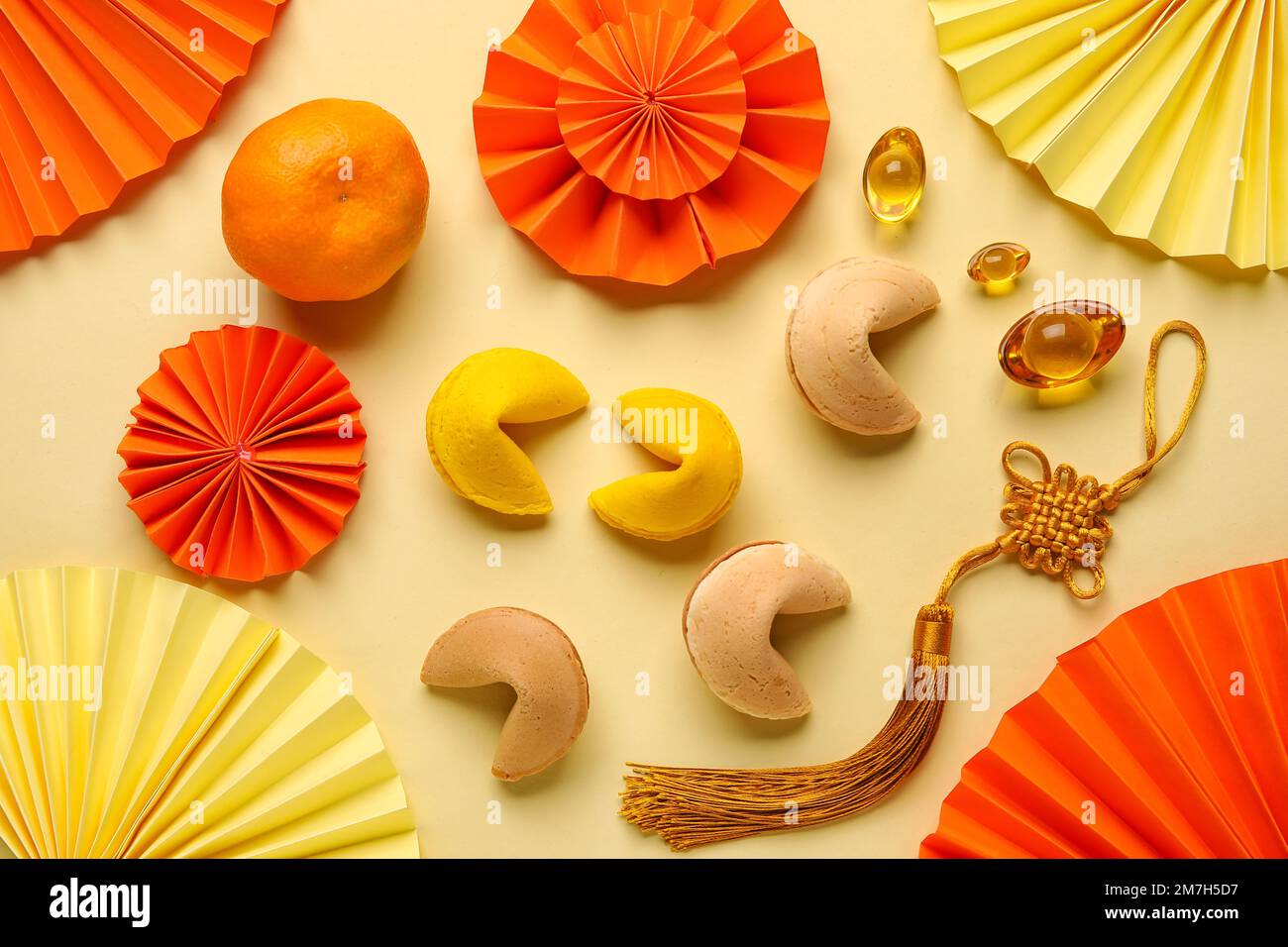 Fortune cookies with mandarin and Chinese symbols on yellow background ...