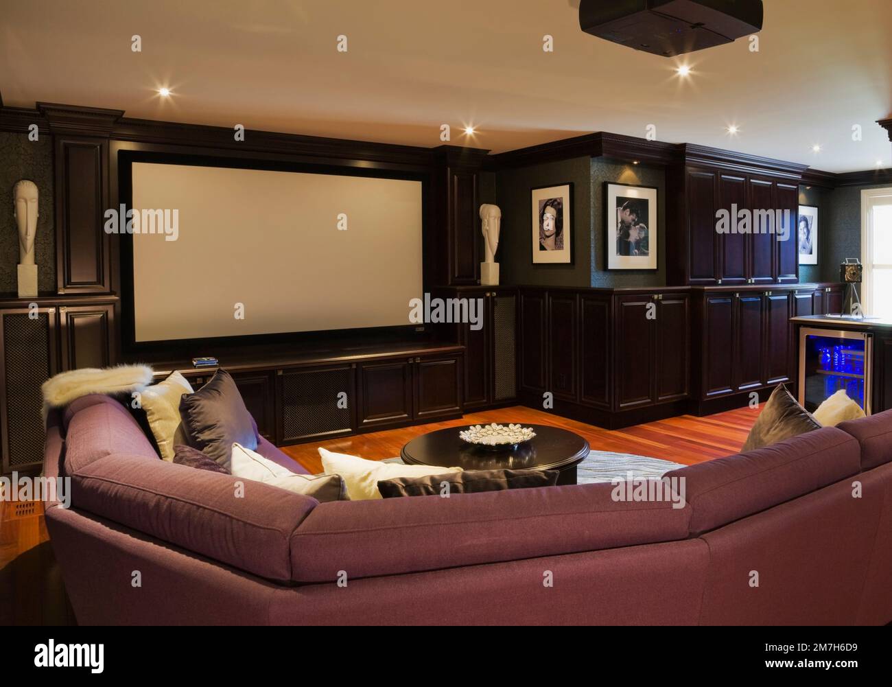 Vintage photos of Hollywood movie stars in home theater room on ...