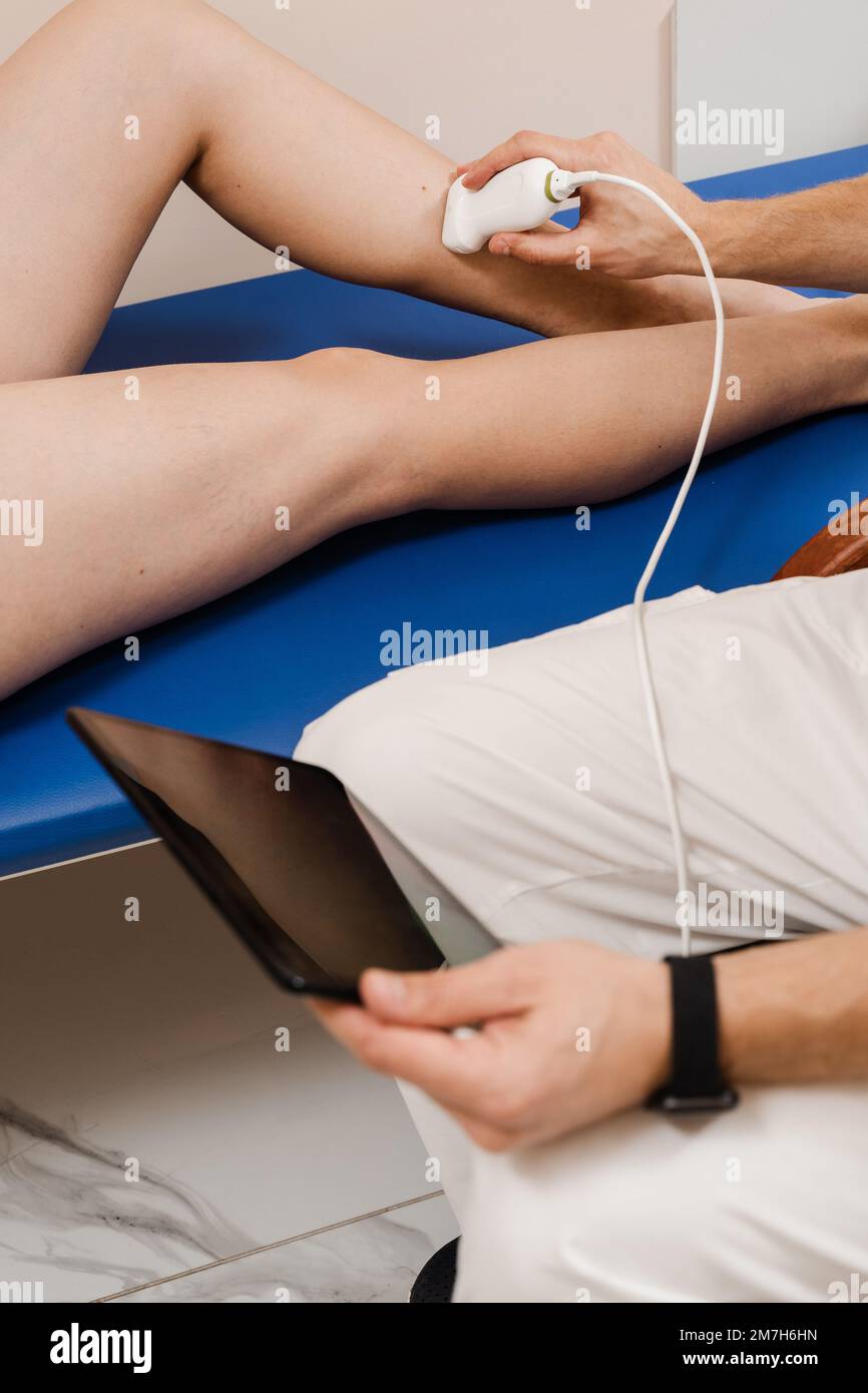 Legs ultrasound scan veins and arteries of woman. Vascular surgeon ...