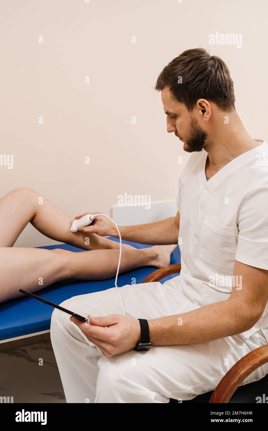 Legs ultrasound scan veins and arteries of woman. Vascular surgeon ...