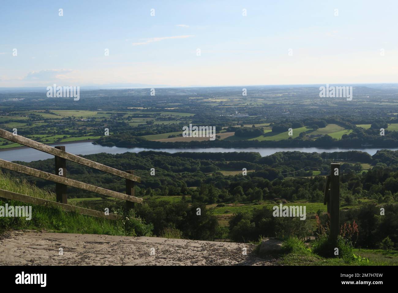 A natural view of a hilly road overlooking a vast landscape of ...