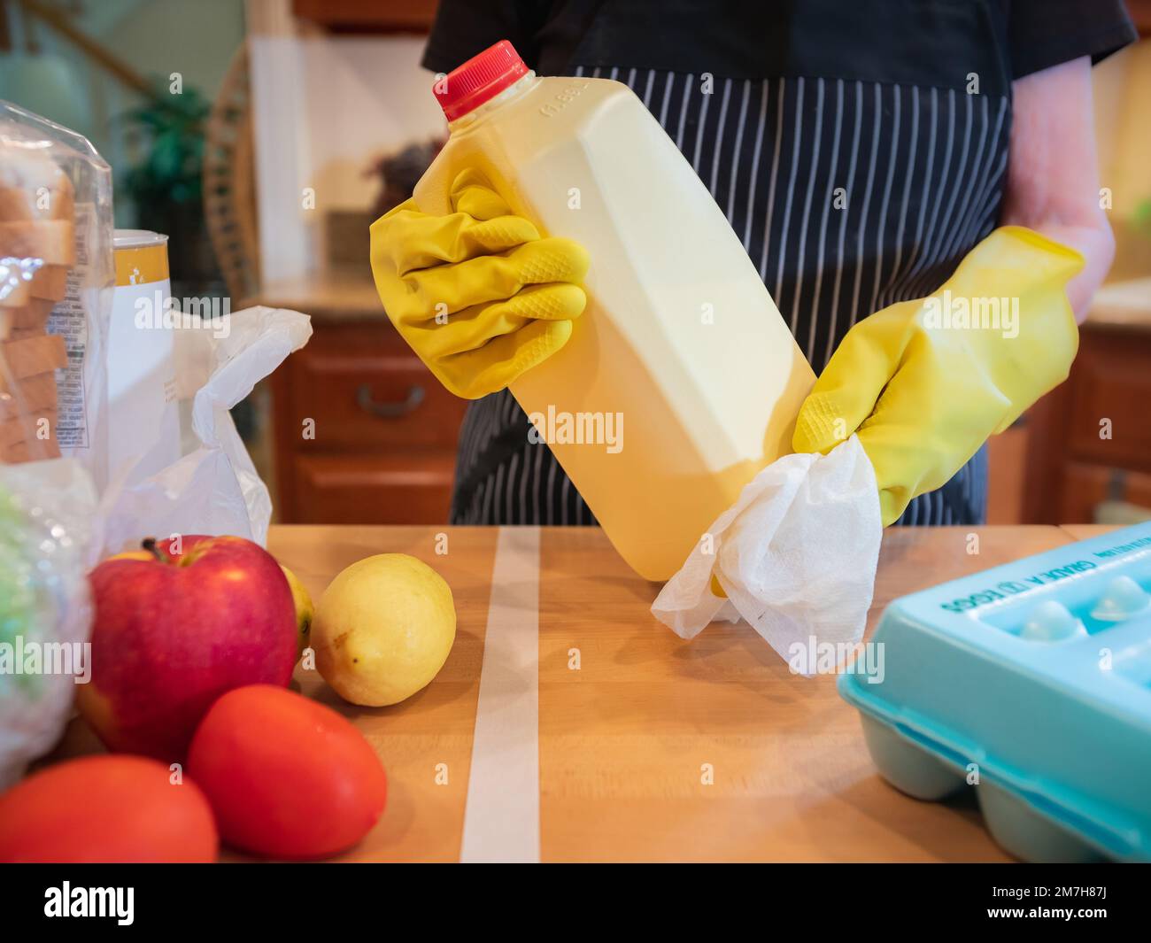 Coronavirus pandemic. Wiping food packages after shopping for groceries ...