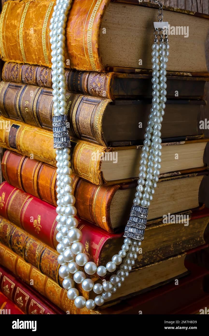 Stack Of Books With Perals Stock Photo - Alamy