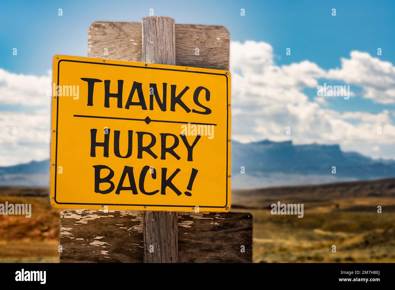 Hurry Back road sign says thanks for staying. It indicates a visitor is ...