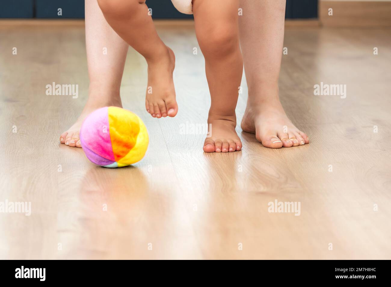 Photo of an unrecognizable child playing with a color ball with his ...
