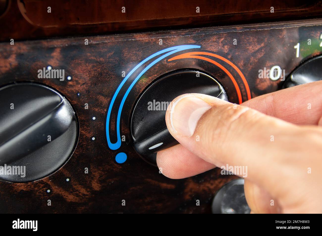 Closeup of a human hand rotating car temperature control in cold ...