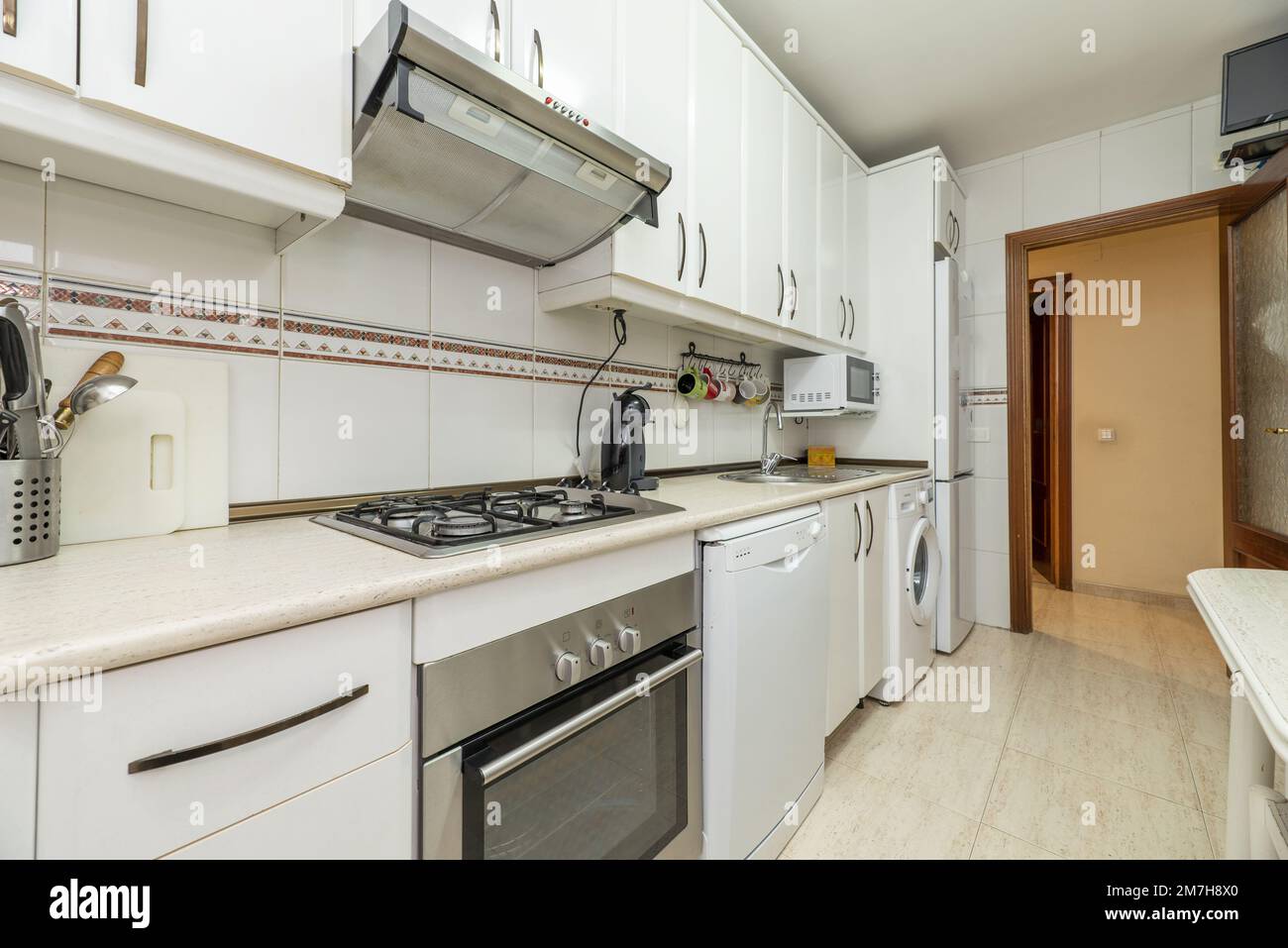 Old kitchen with white cabinets and appliances of all kinds and colors ...