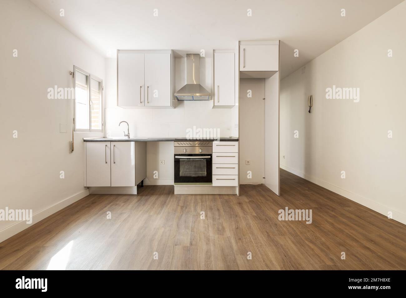 kitchen open to empty room recently furnished with conventional design ...