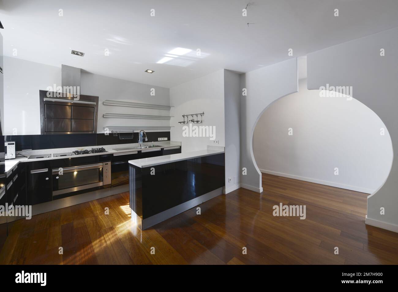 Open design kitchen with characteristic access in plaster wall and ...