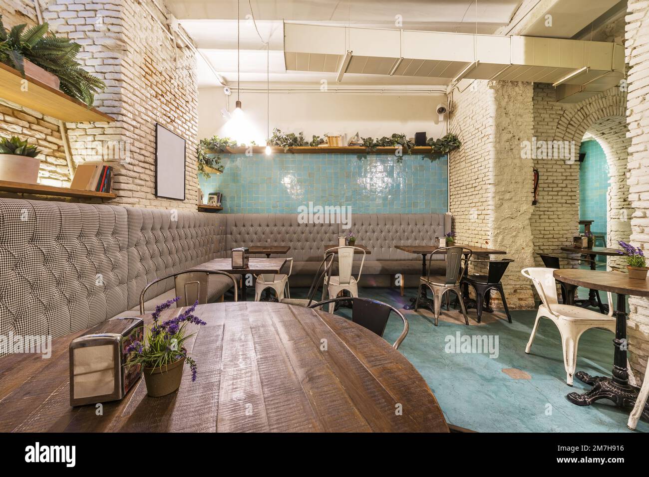 Living room of a restaurant with a sofa running along the entire ...