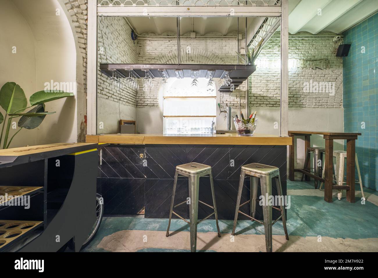 Hall of a restaurant with an industrial style bar counter made of wood ...