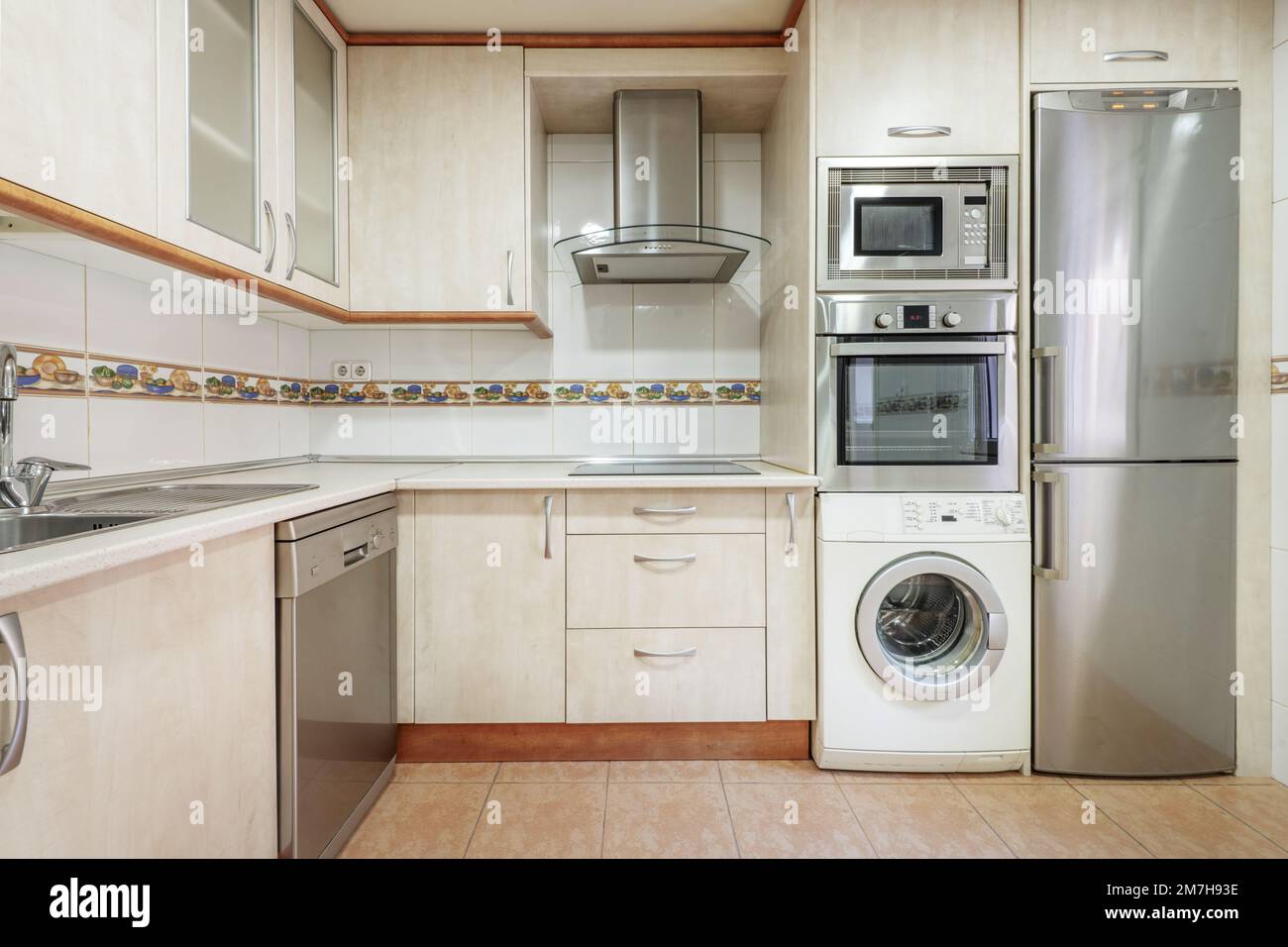 Kitchen furnished with light madra color furniture and details in ...