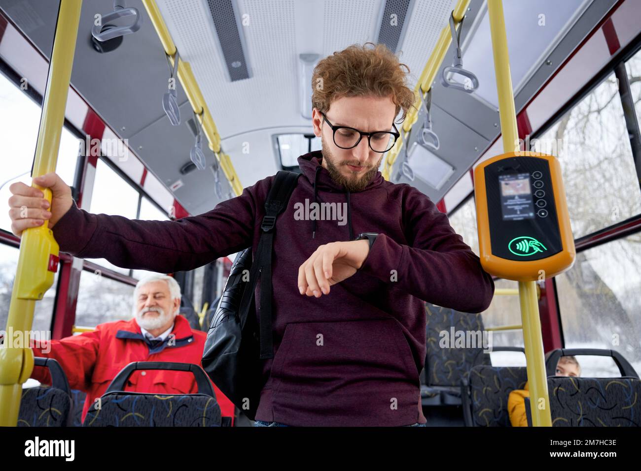 Portrait of ginger curly haired wearing glasses and wrist watch in ...
