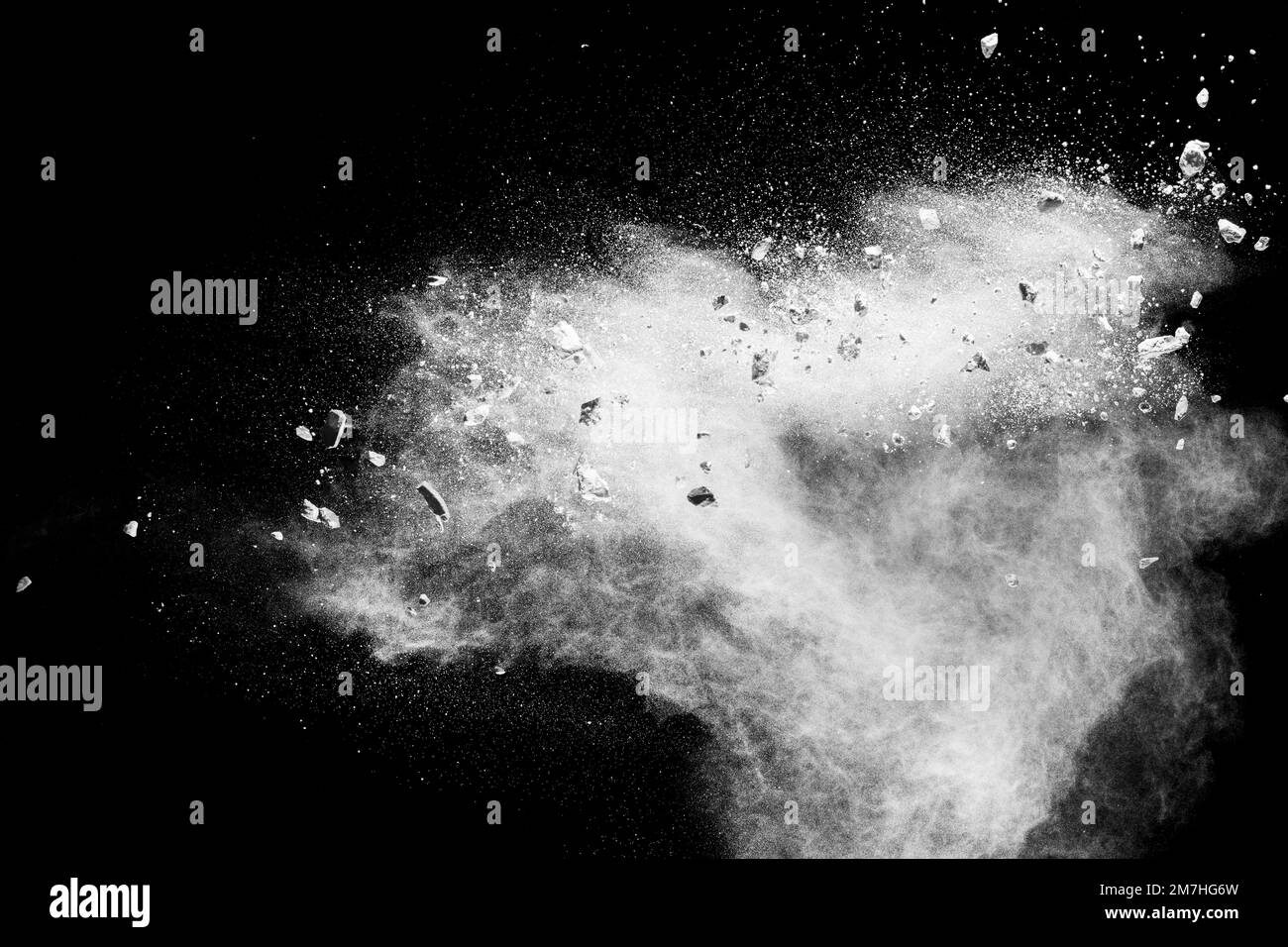 White powder with small stones on black background. Small granite rock ...