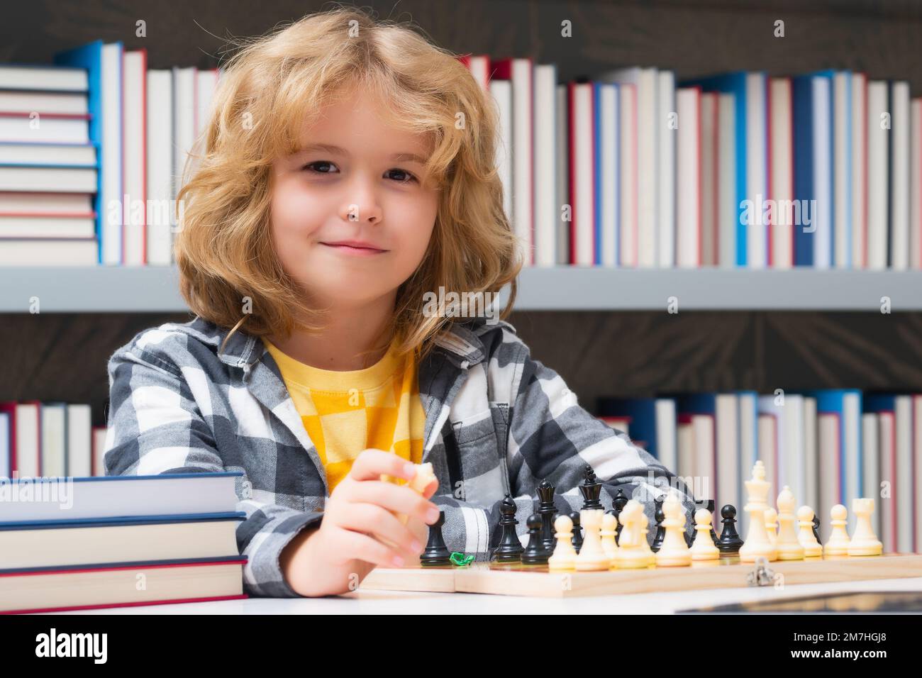 Smart child. Clever child thinking about chess. Portrait of clever kid ...