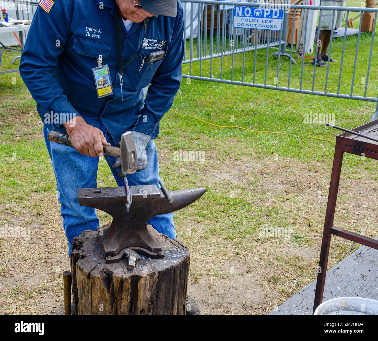 NEW ORLEANS, LA, USA - APRIL 29, 2022: Blacksmith shapes a metal tool ...