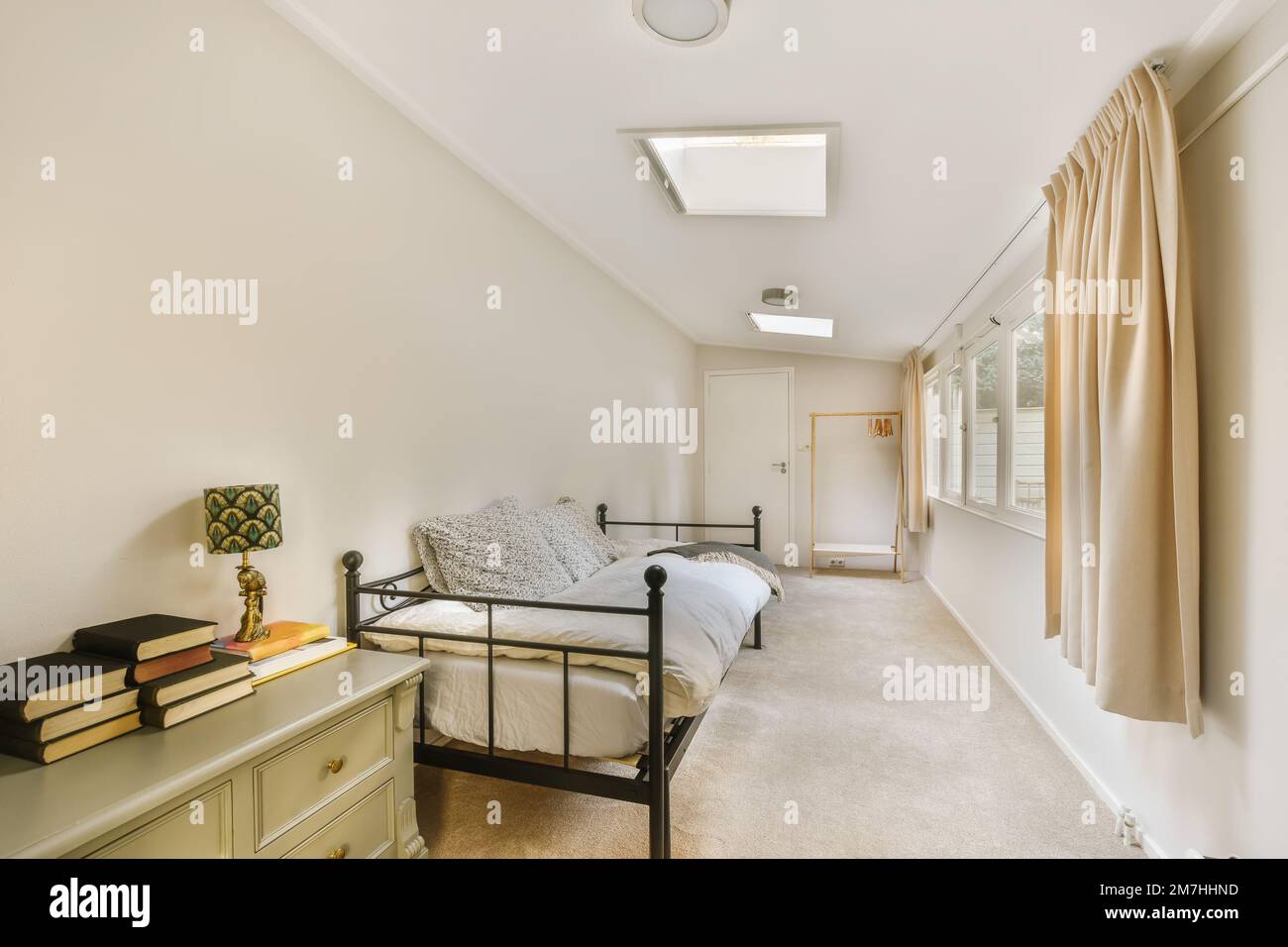 a bedroom with a bed, dresser, and window in the room that looks like ...