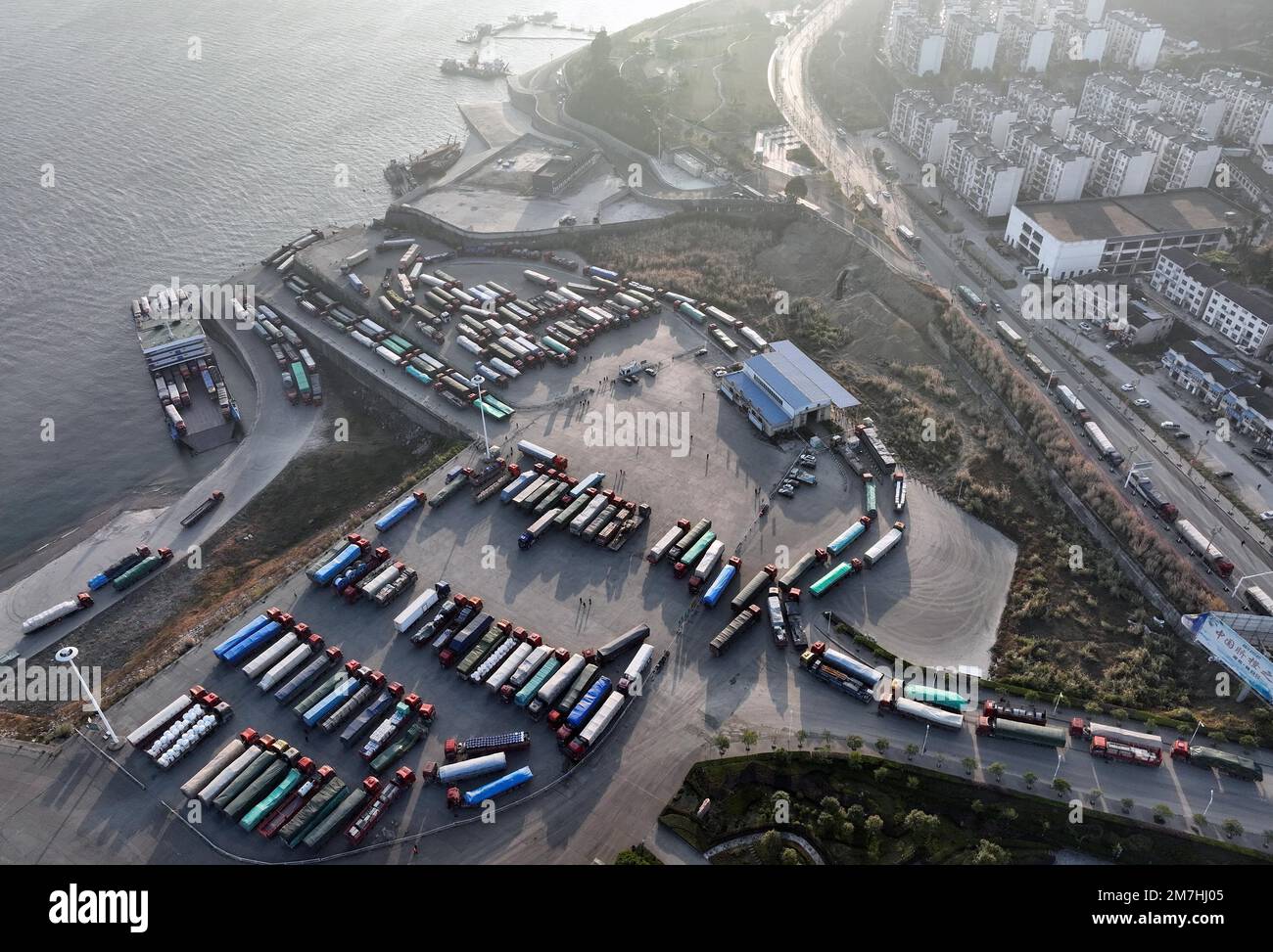 Aerial photo shows trucks waiting for boarding a ship at the Yinxingtuo ...