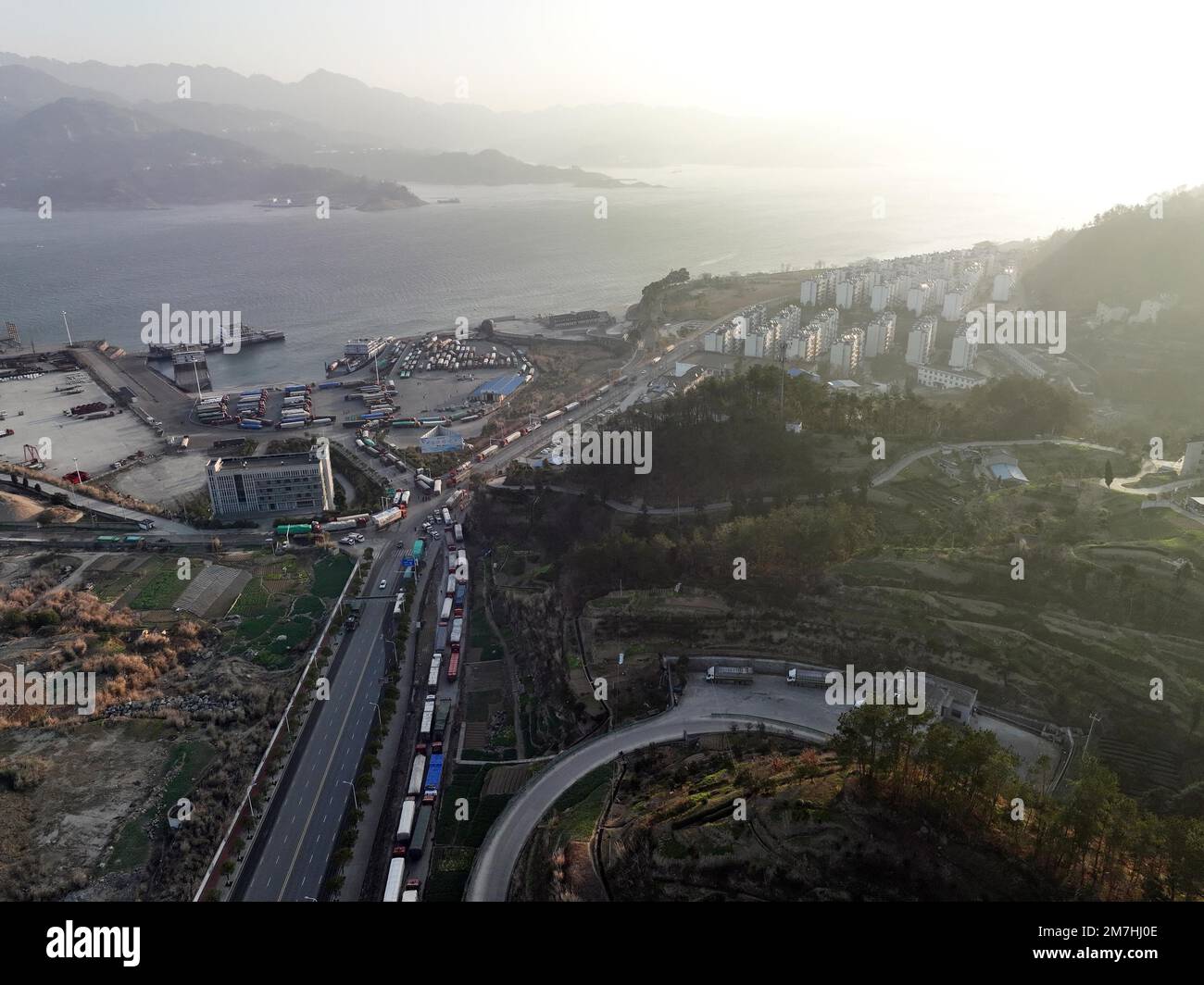 Aerial photo shows trucks waiting for boarding a ship at the Yinxingtuo ...