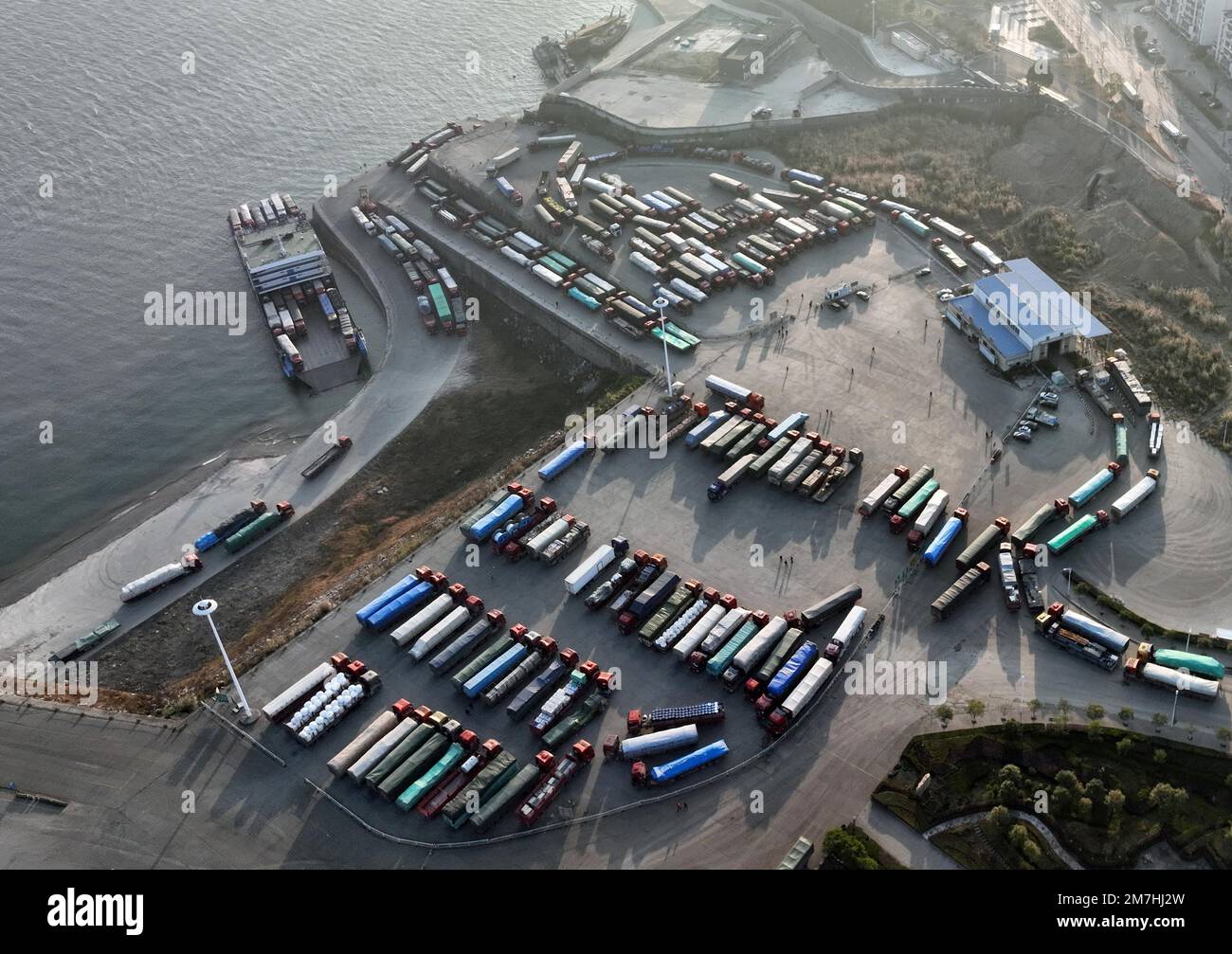 Aerial photo shows trucks waiting for boarding a ship at the Yinxingtuo ...
