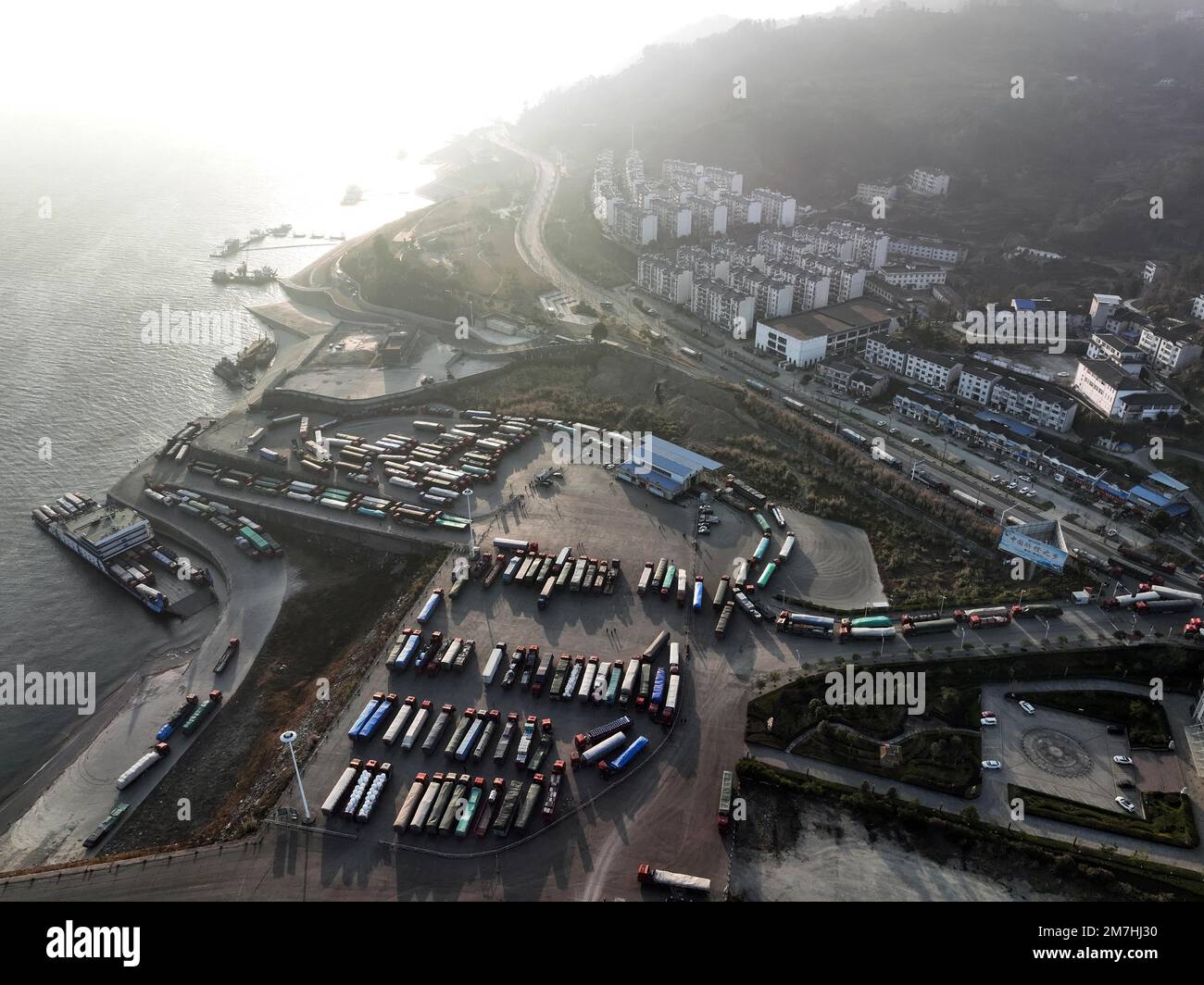 Aerial photo shows trucks waiting for boarding a ship at the Yinxingtuo ...