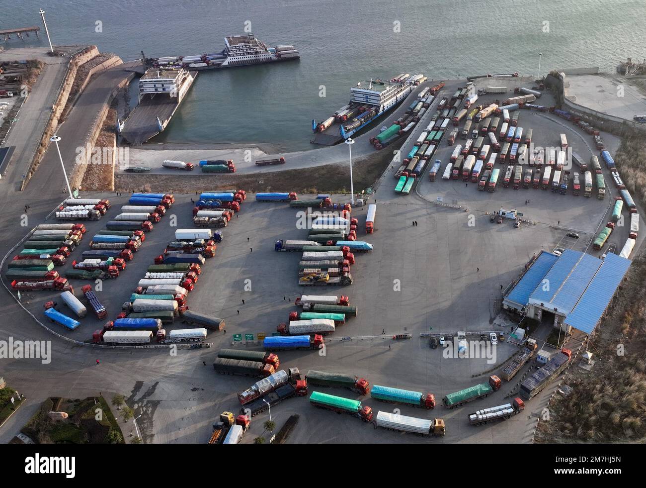 Aerial photo shows trucks waiting for boarding a ship at the Yinxingtuo ...