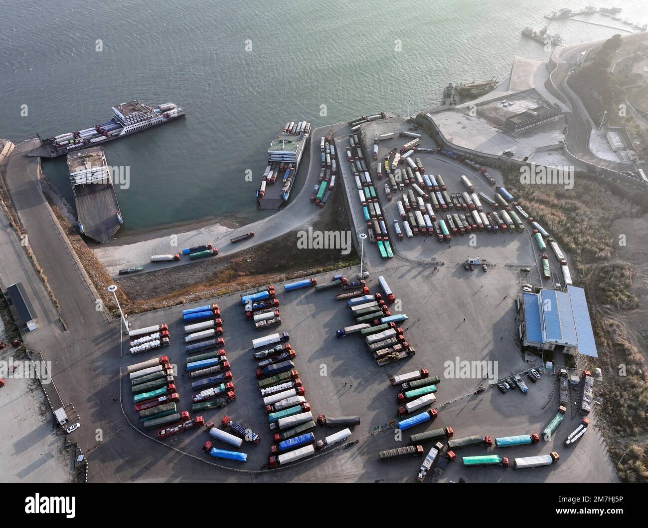 Aerial photo shows trucks waiting for boarding a ship at the Yinxingtuo ...