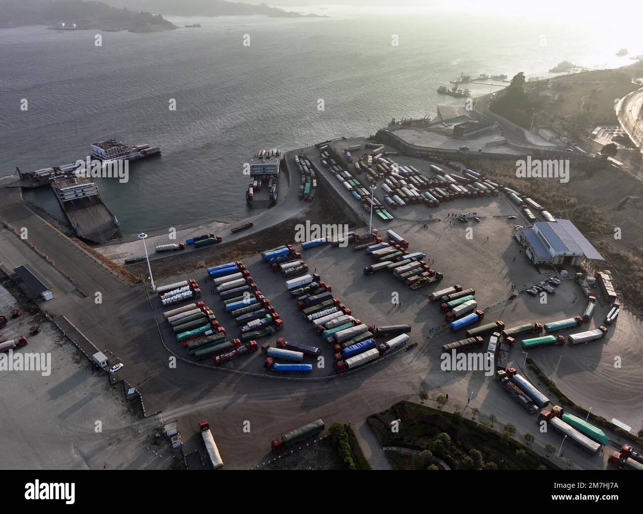 Aerial photo shows trucks waiting for boarding a ship at the Yinxingtuo ...