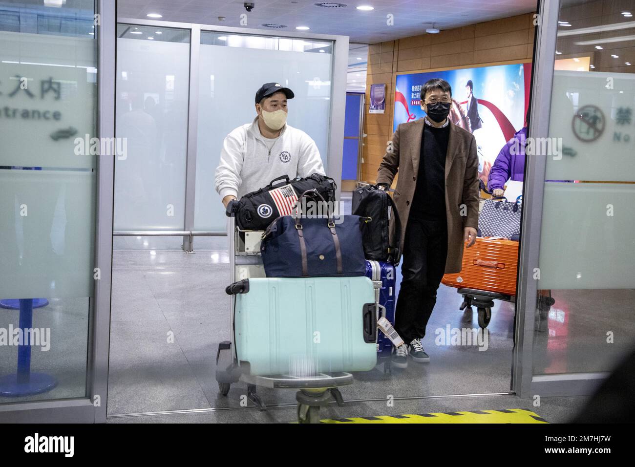 Inbound passengers walk out of the entry passage in the international ...